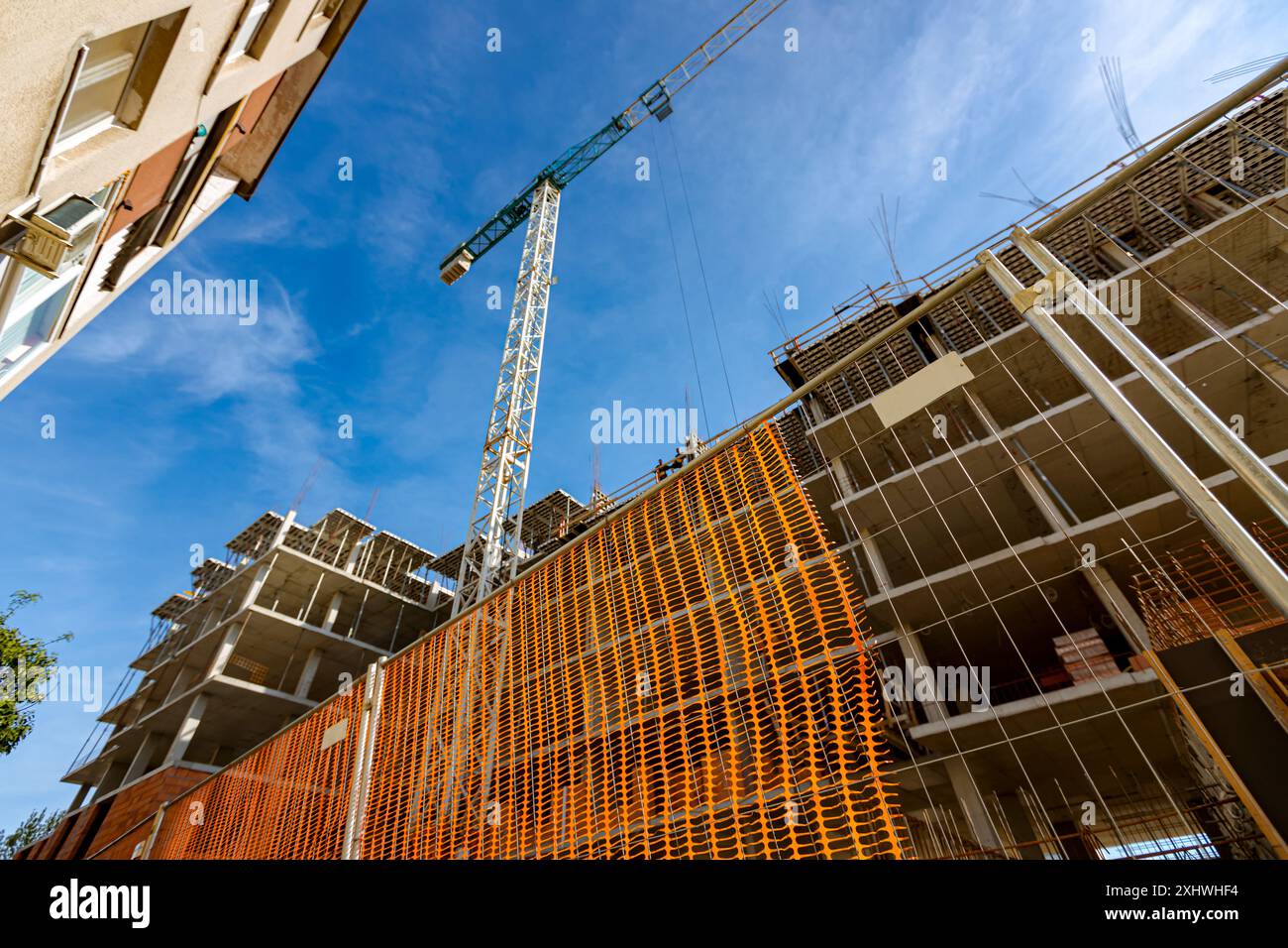 Confined space with orange, plastic, safety mesh is placed around ...
