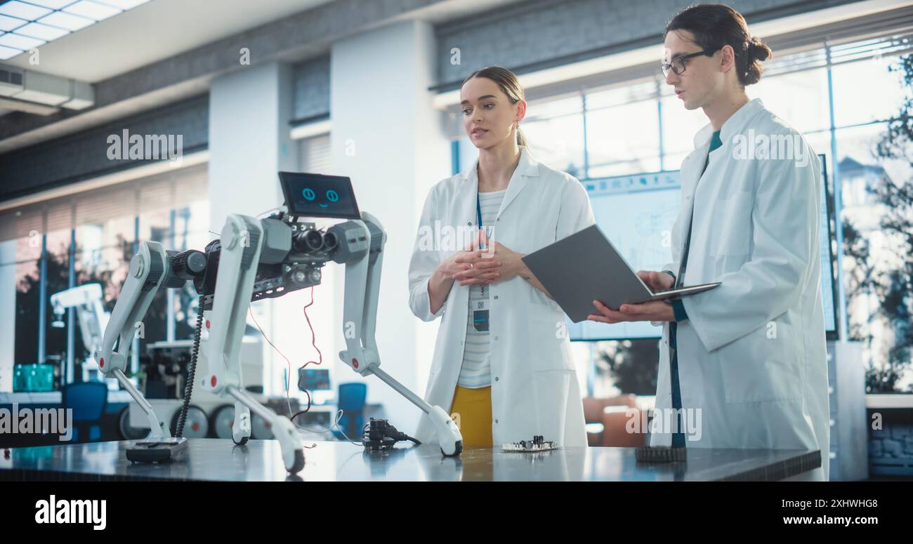 Male Project Manager and Female Machinery Operator Collaborate on a Mobile Robot Animal Project ...