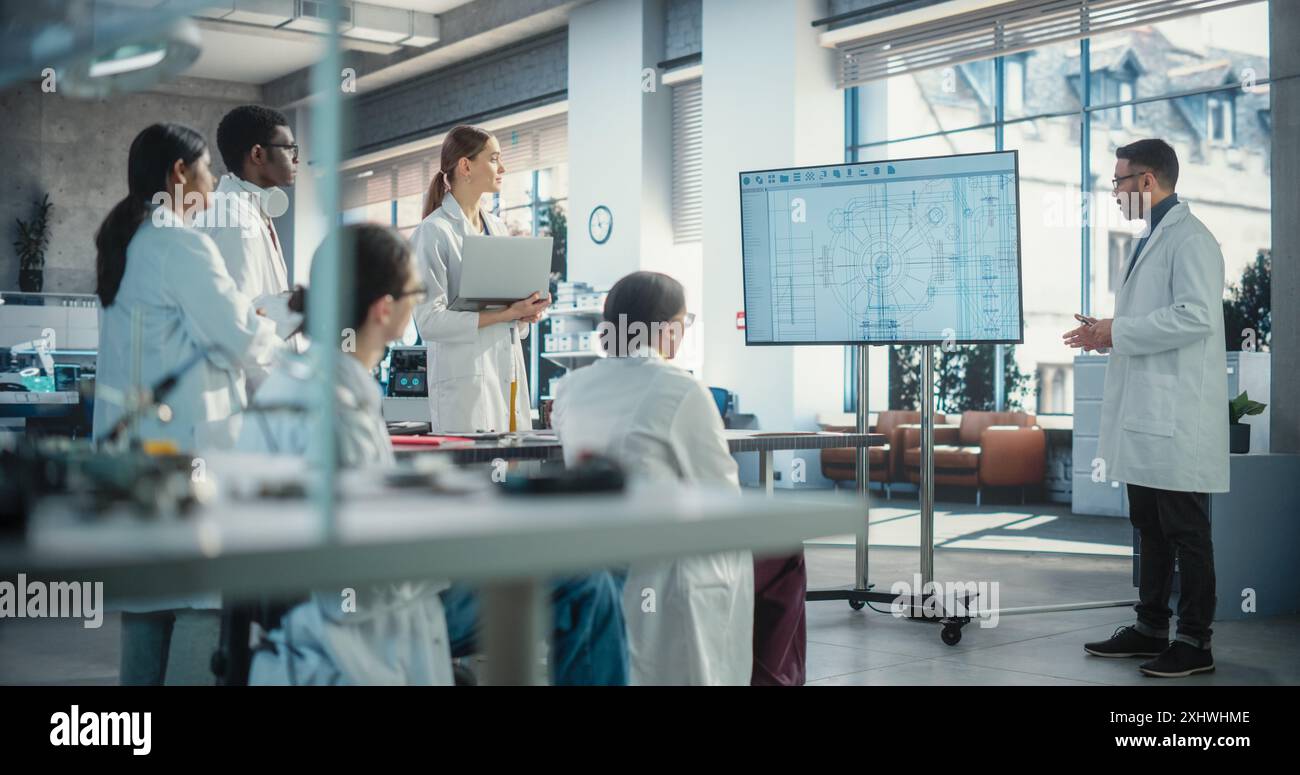 Diverse Team Of Males And Females Discussing Ideas In Technological Modern Startup Lab Group Of