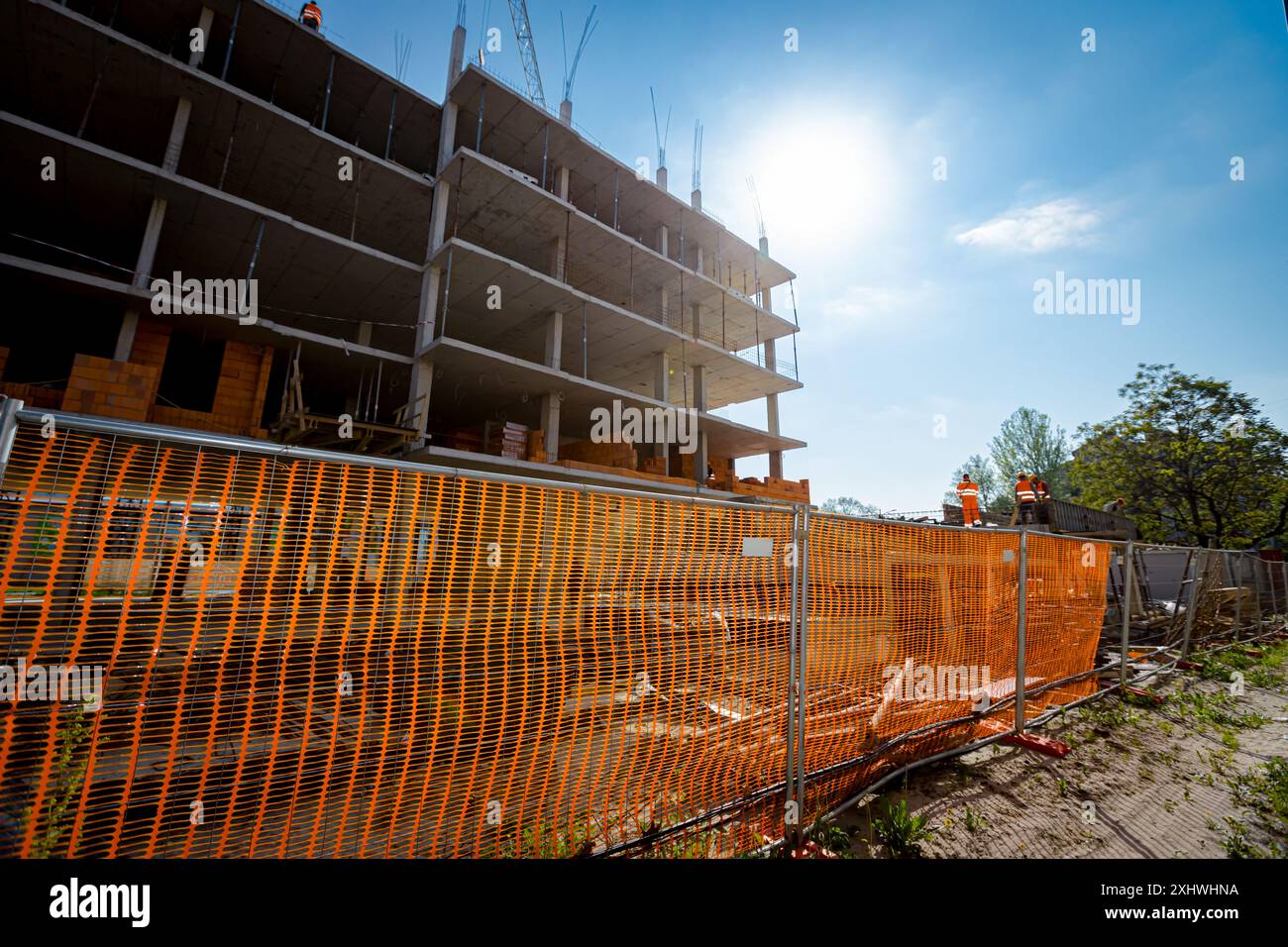 Confined space with orange, plastic, safety mesh is placed around the ...