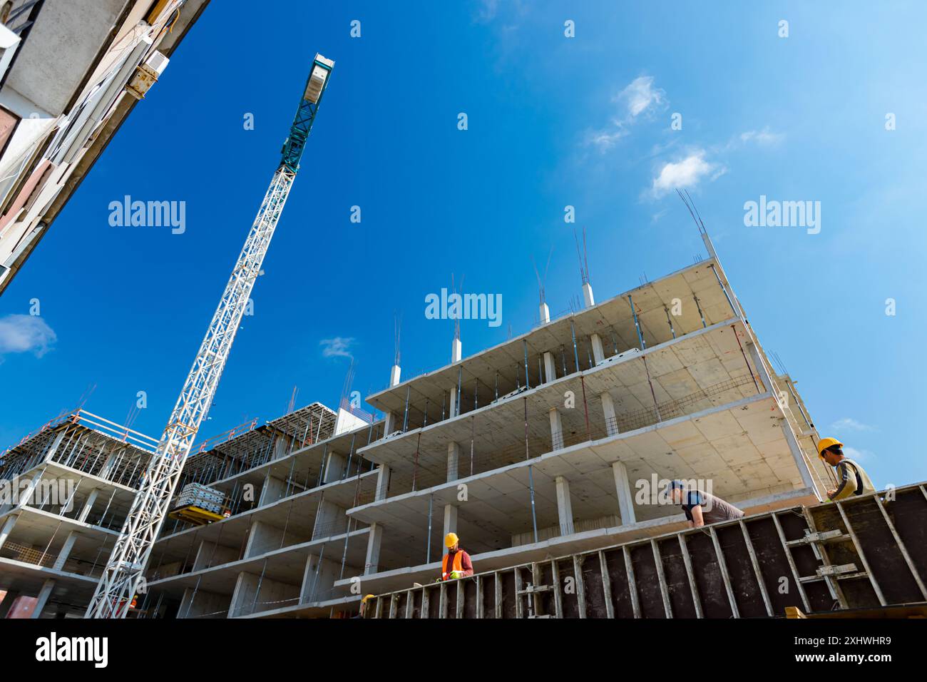Concrete skeleton of new unfinished multi-storey building, residential ...