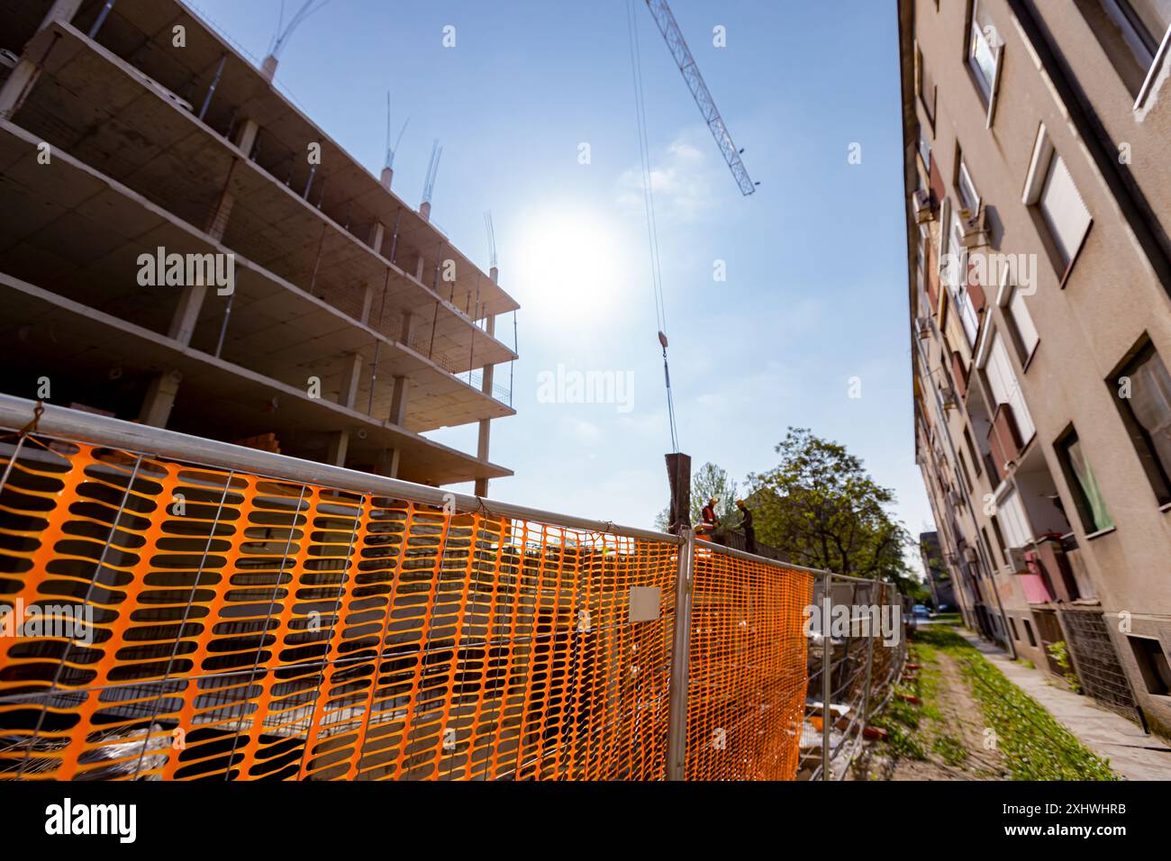 Confined space with orange, plastic, safety mesh is placed around the ...