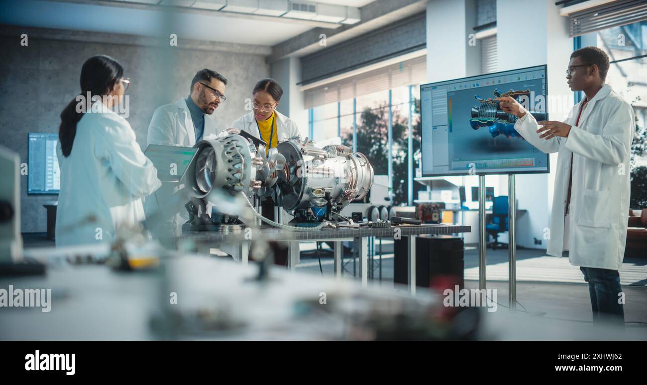 Diverse Professional Jet Engine Researchers Discussing Work, Using ...