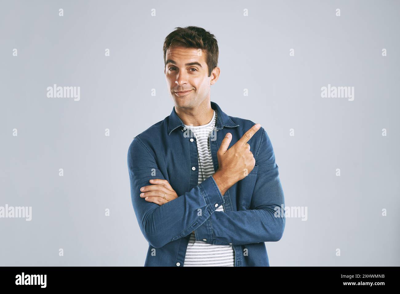 Portrait, pointing and man with review, option and model on grey studio ...