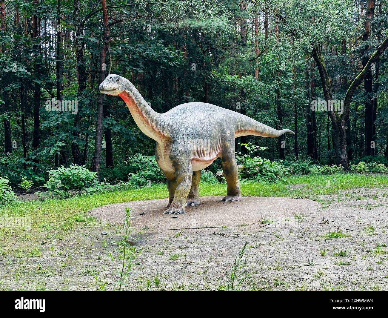 Realistic figure of the Vulcanodon dinosaur in the forest in Kazimierz, Sosnowiec. The park ...