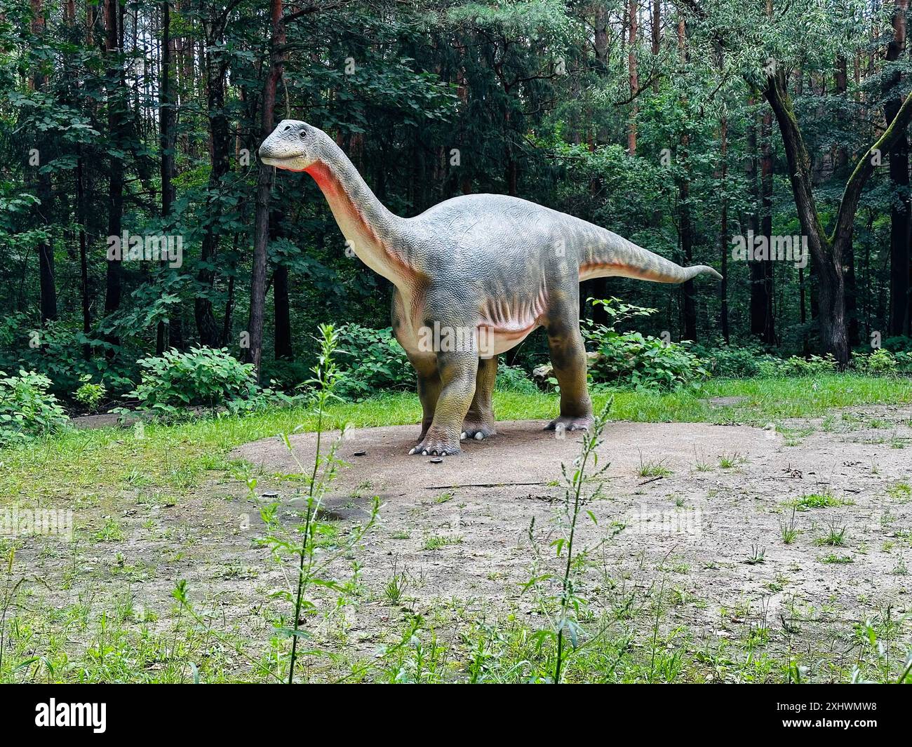 Realistic figure of the Vulcanodon dinosaur in the forest in Kazimierz, Sosnowiec. The park ...