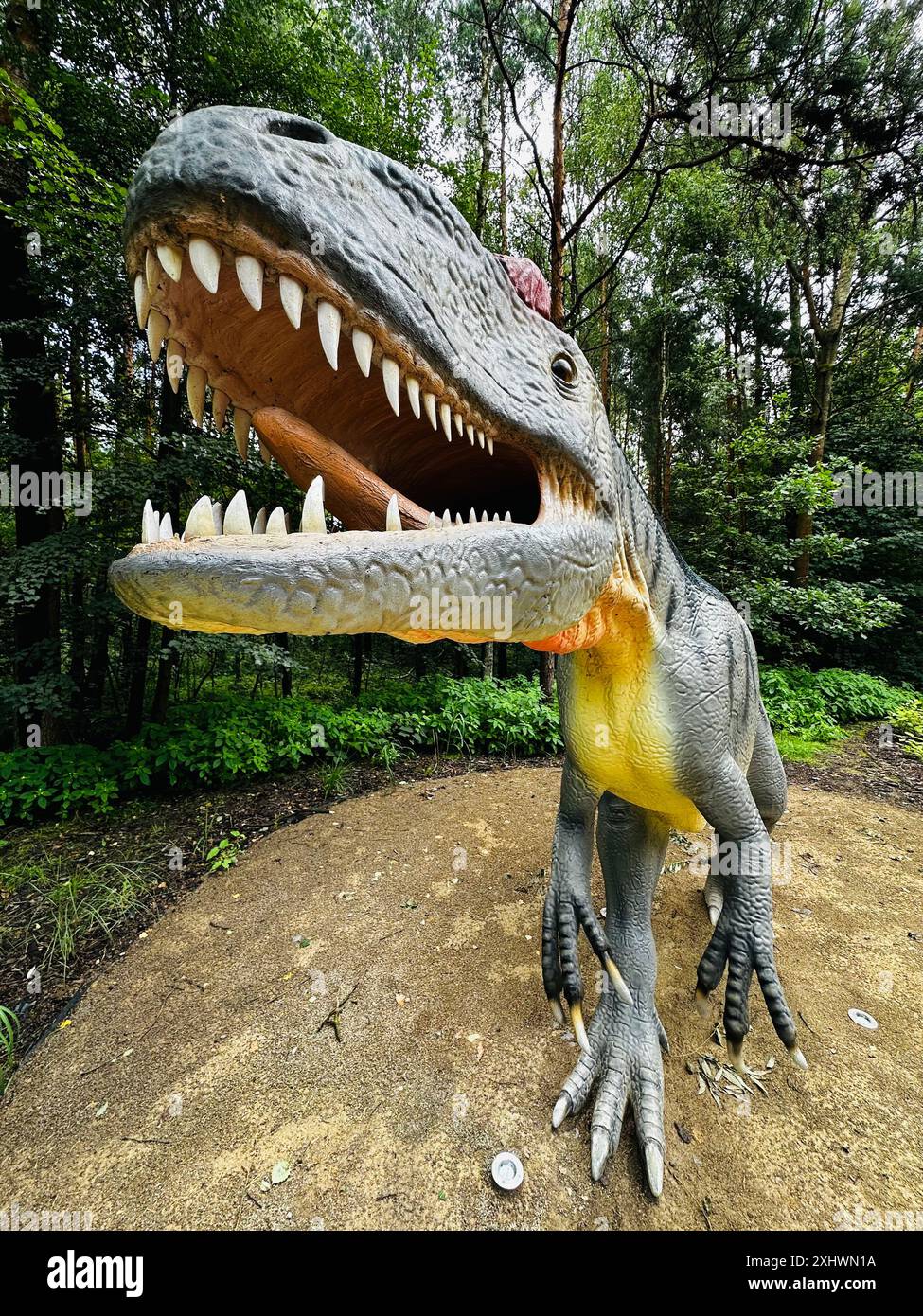 Realistic figure of an Allosaurus dinosaur inforest park in Kazimierz Sosnowiec. Prehistoric ...