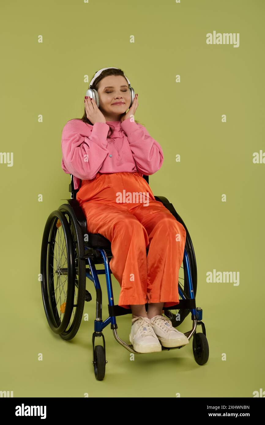 A young brunette woman with a disability sits in a wheelchair in a ...