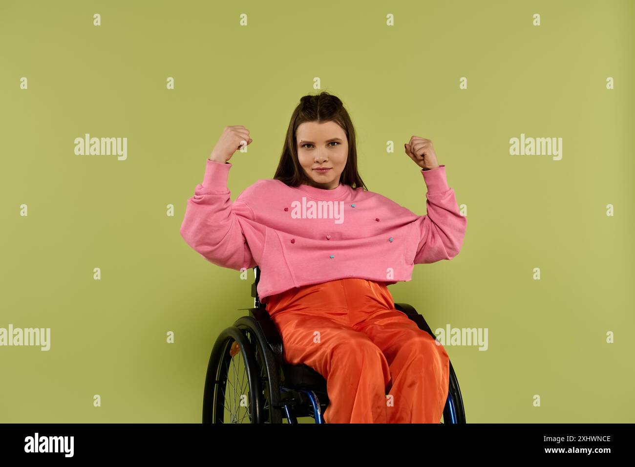 A young brunette woman with a disability sits in a wheelchair in a ...