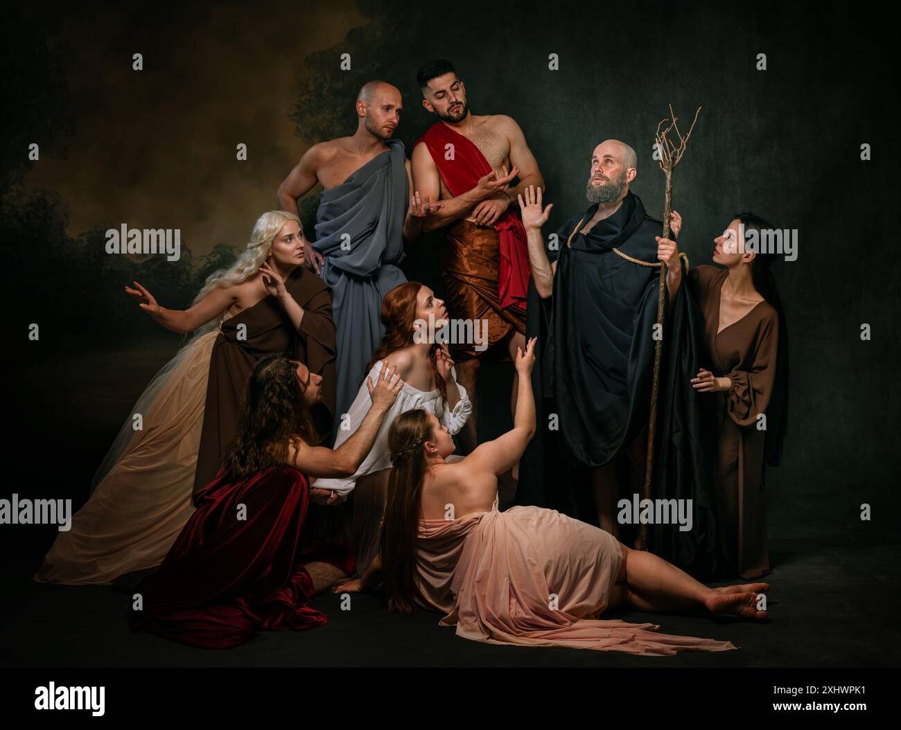 People in classical attire gather around central figure holding staff ...