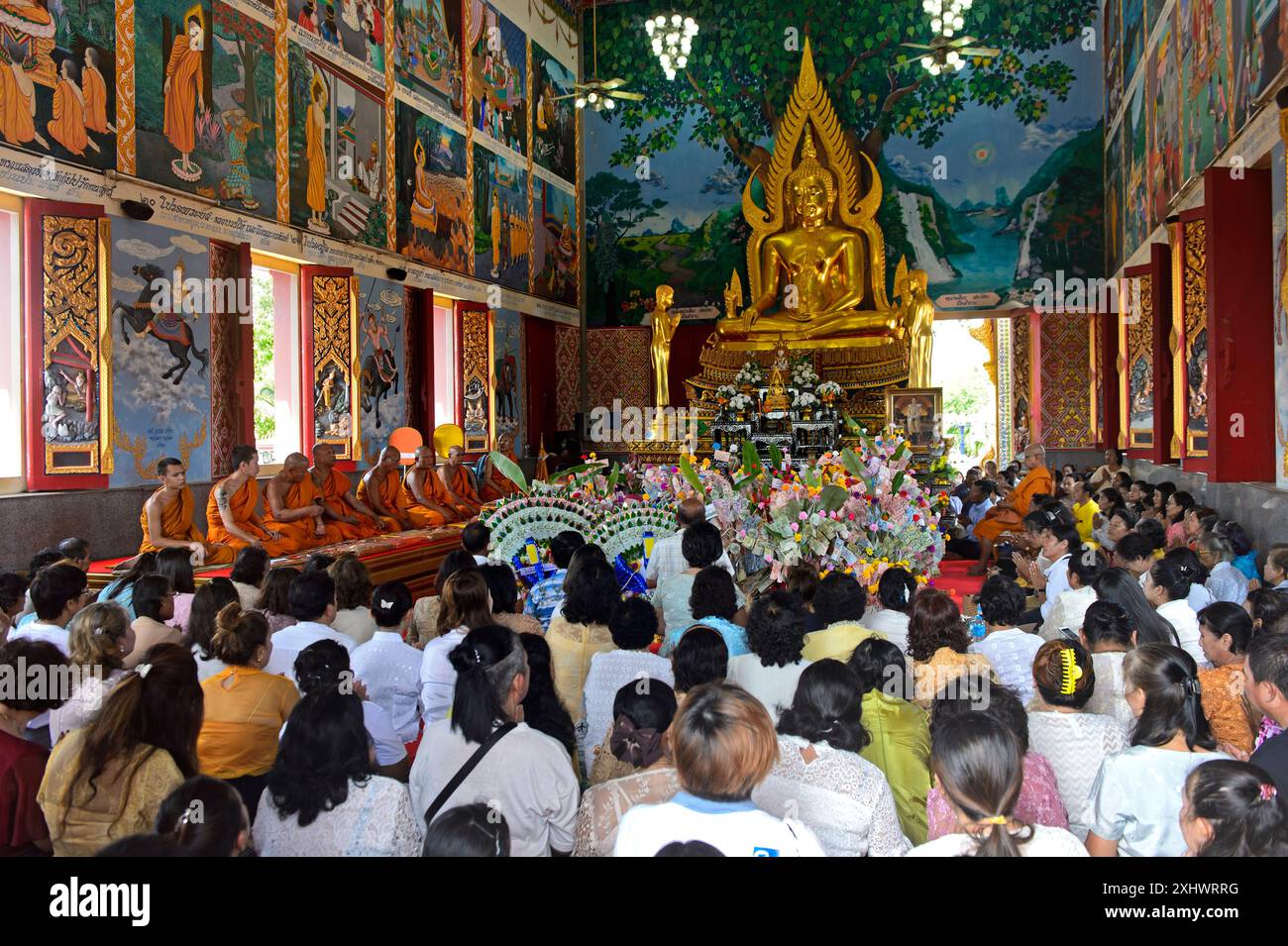 Buddhist believers at a prayer ceremony in the prayer hall at Wat Plai ...