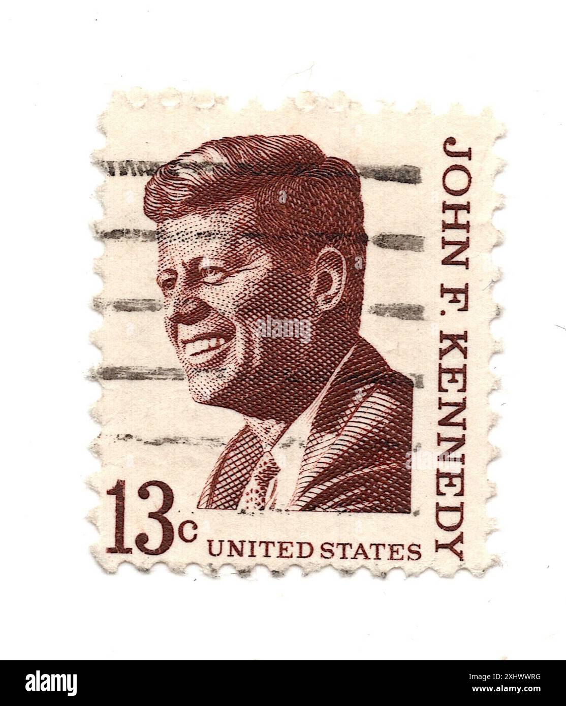 A vintage John F. Kennedy postage stamp from the USA on a white ...