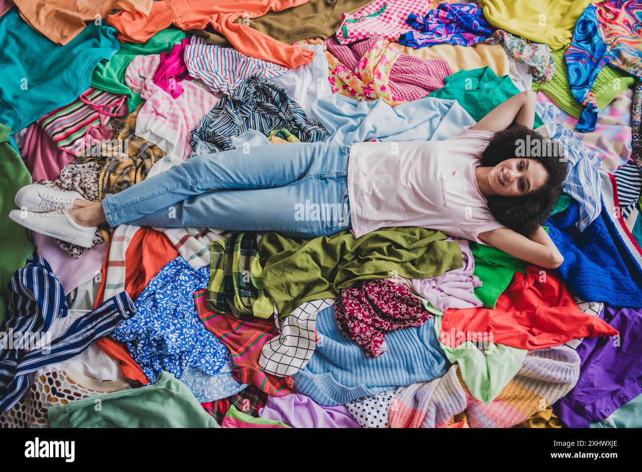 Full size high angle view photo of young woman lying messy pile stack ...