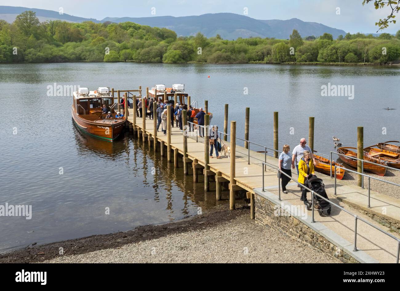 People leaving boat launch at Keswick jetty Derwentwater in spring Lake ...