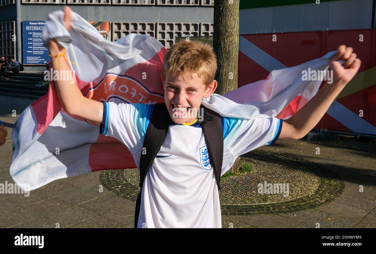 Young England football fan in Berlin draped in England flag cheering ...