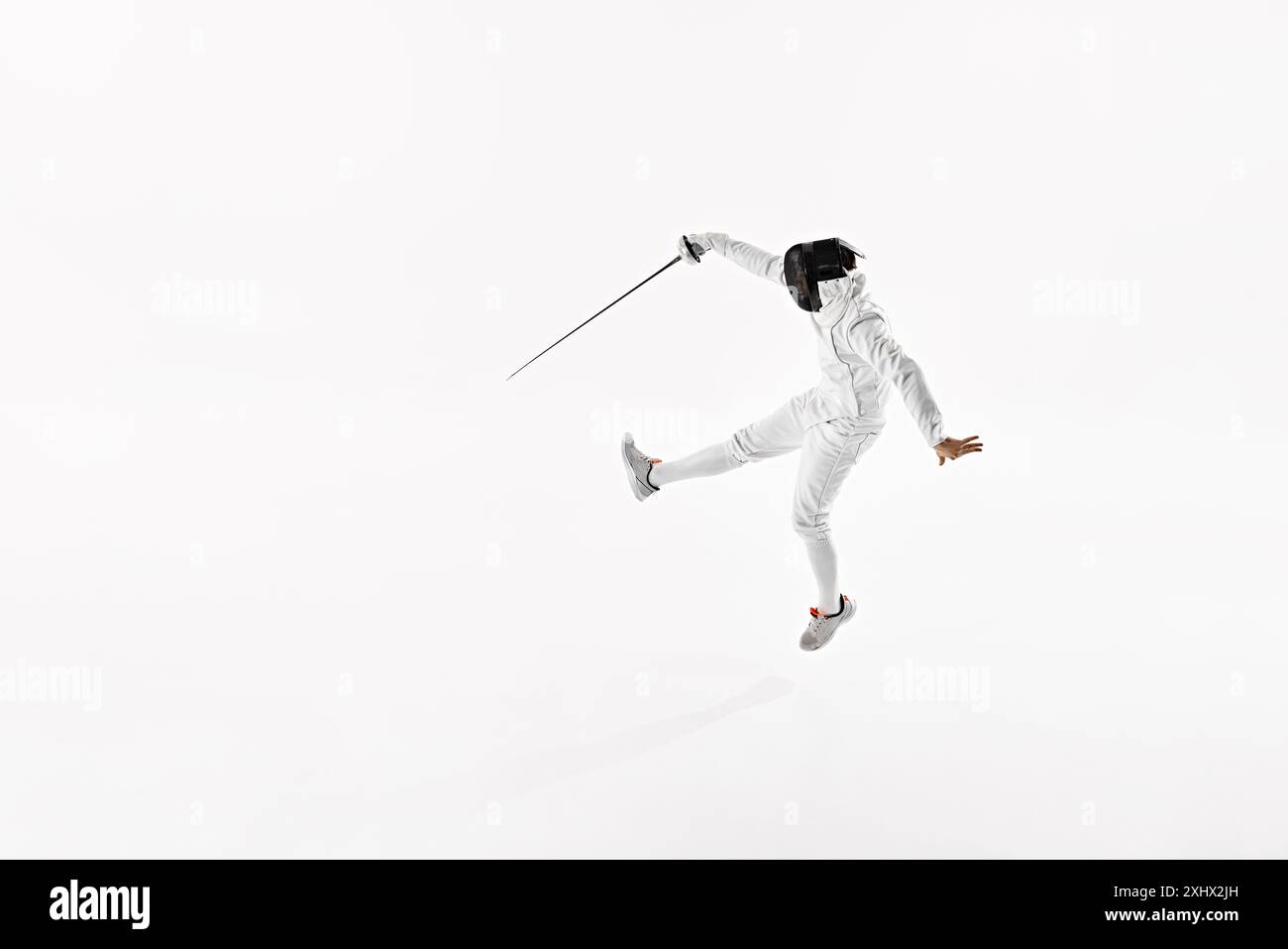 Fencer in complete white attire, including mask, depicted in mid-leap ...