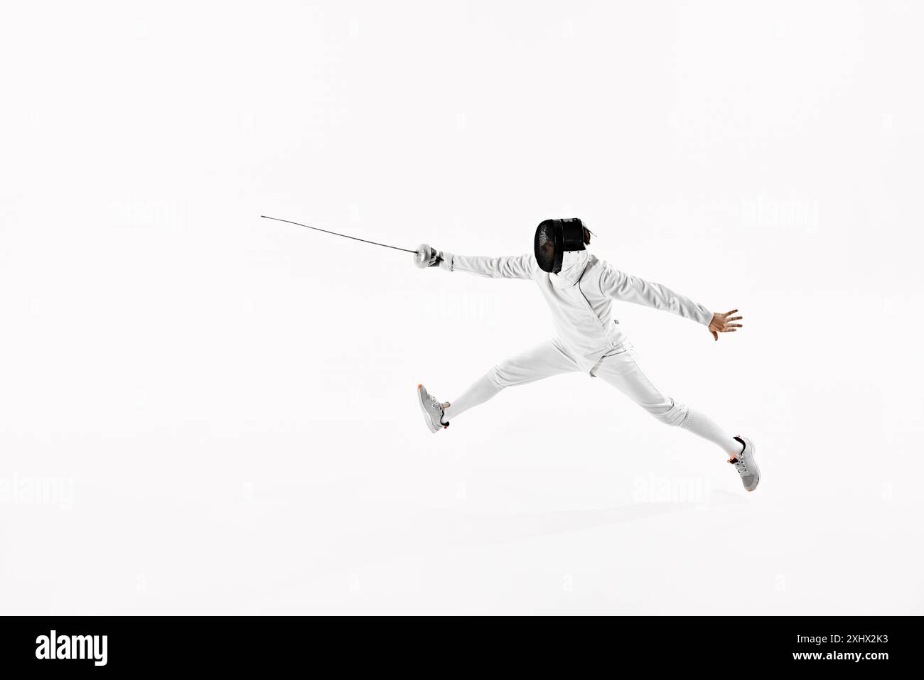 Fencer in white gear and mask with their rapier extended forward ...