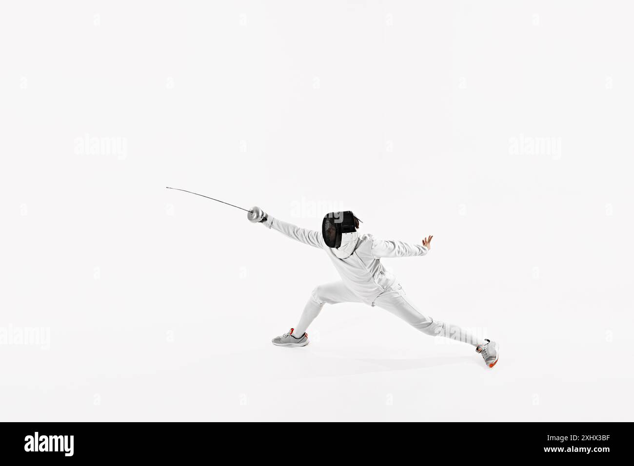 Fencer dressed in full white attire, including mask, executing long ...