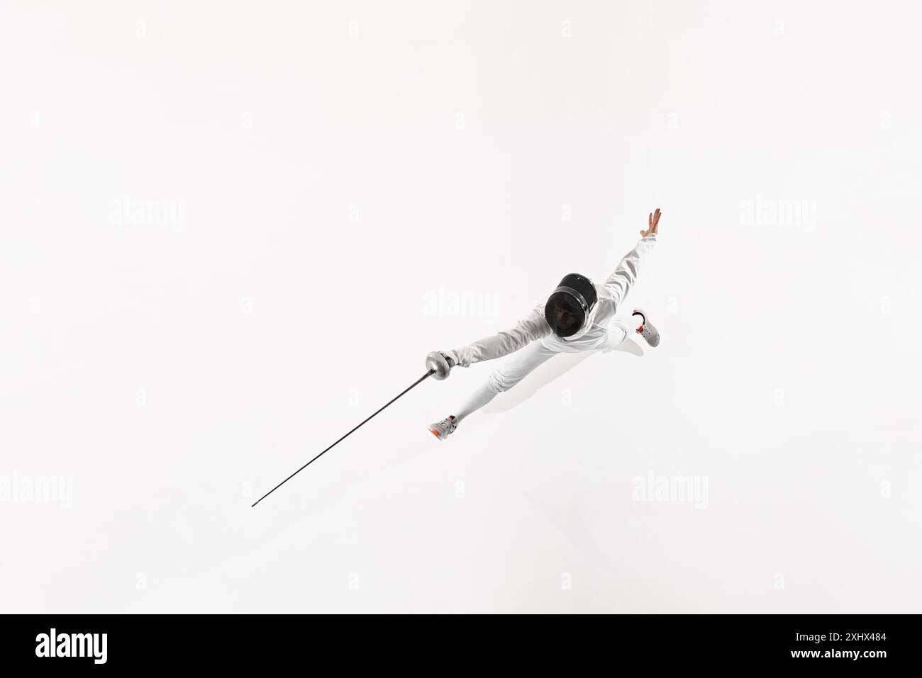 Dynamic photo of young athletic man, fencer training in motion his ...