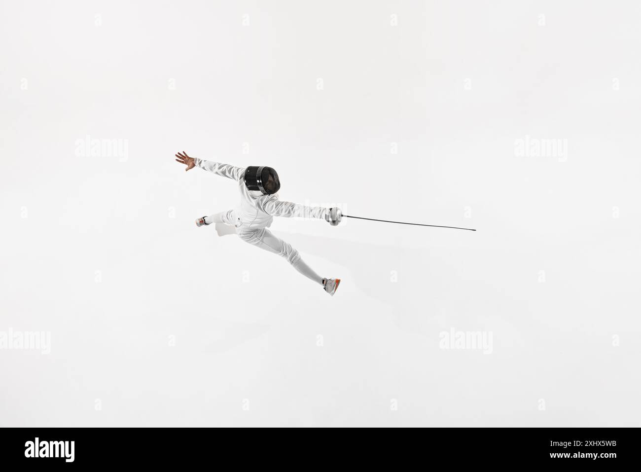 Dynamic photo of young athletic man, fencer training in motion his ...