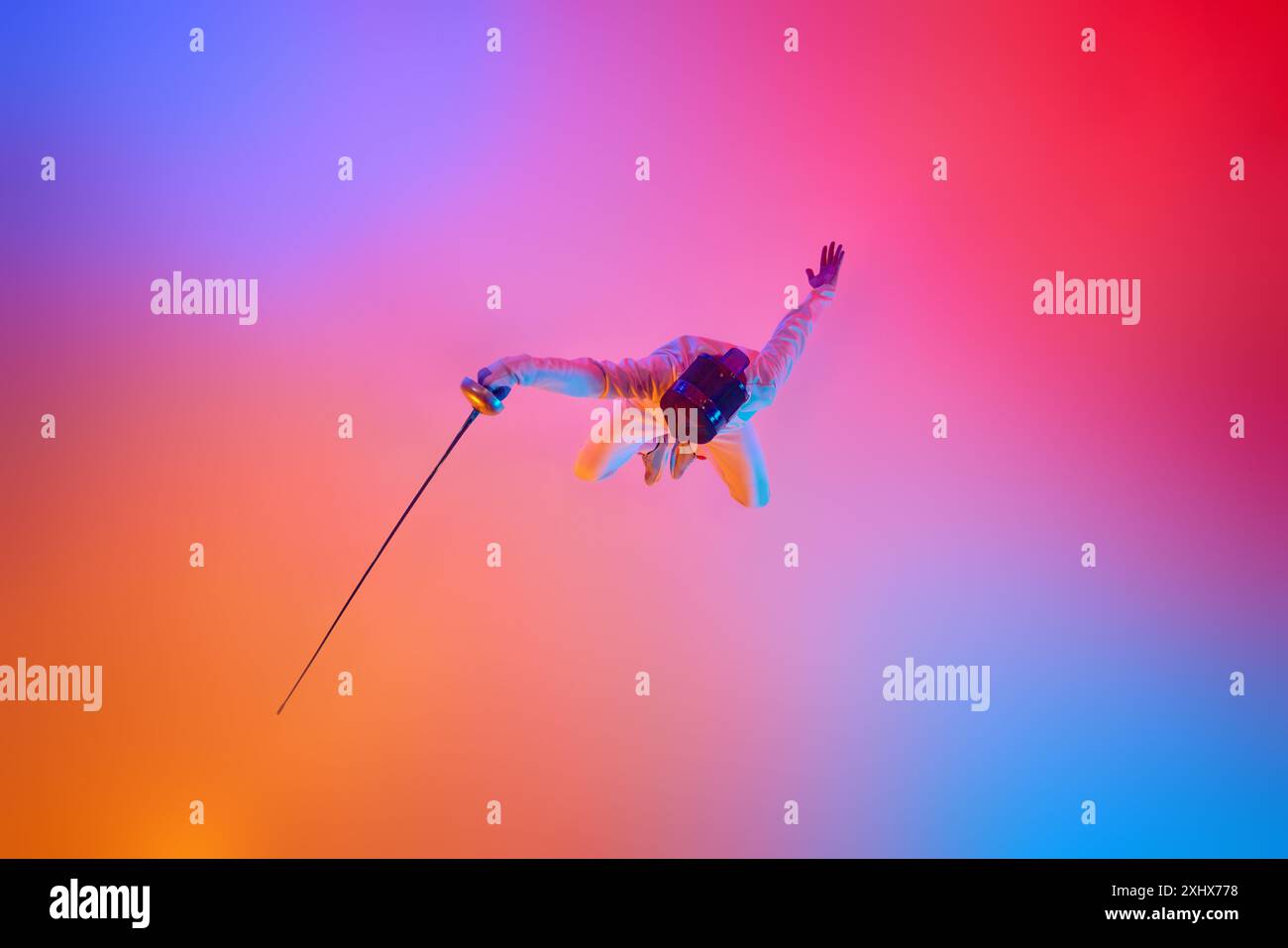 Fencer in uniform and mask in impressive jump, holding rapier forward ...