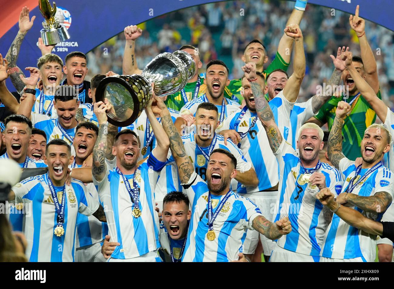 Argentina's Lionel Messi holds the trophy as celebrating with teammates ...