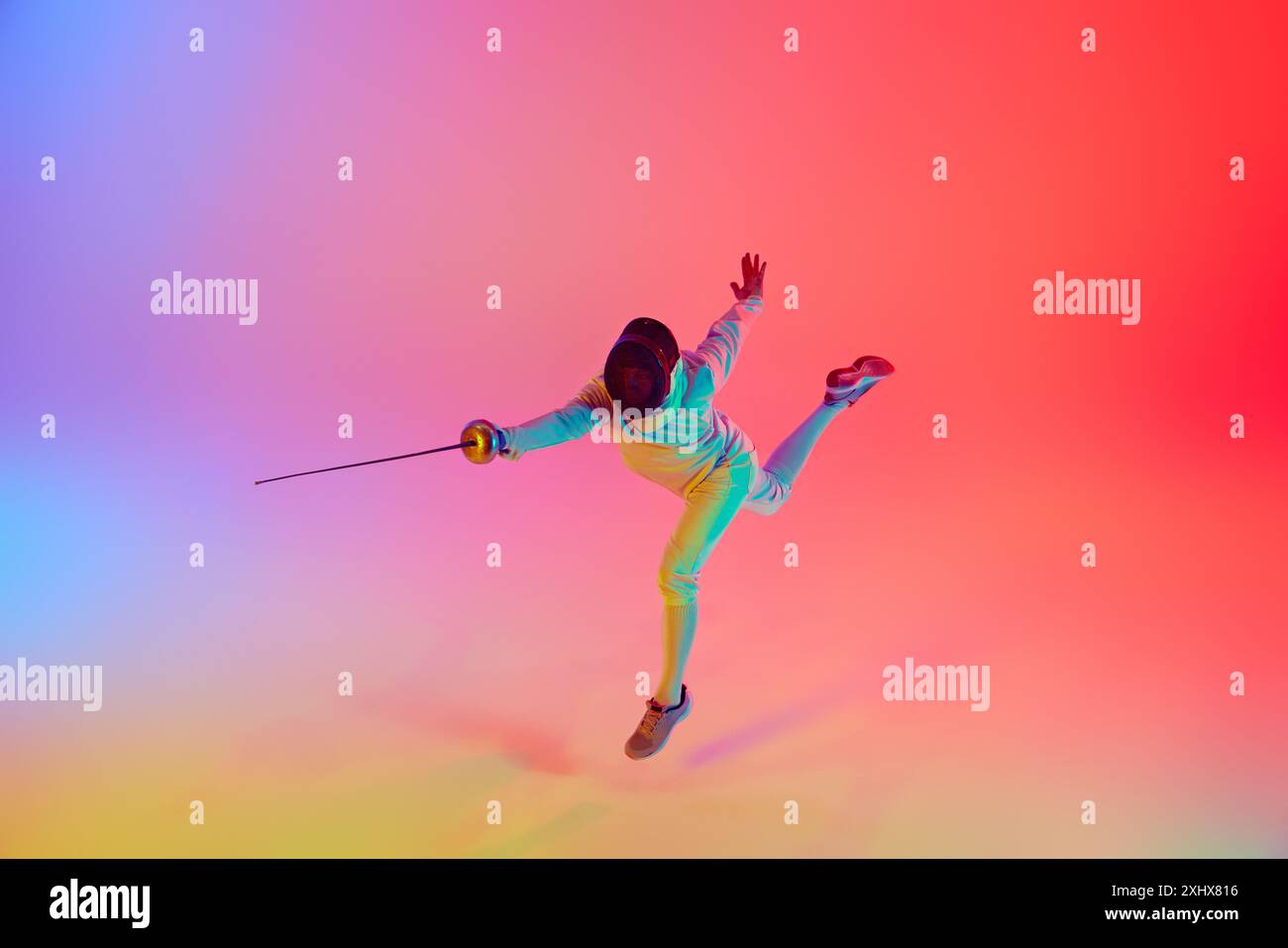 Fencer in mid-lunge, clad in white fencing suit and mask, with their ...