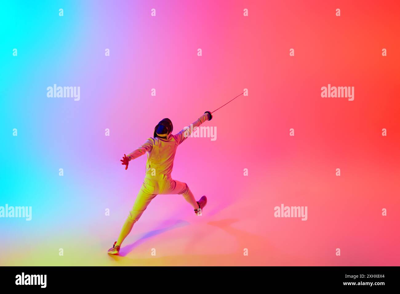 Fencer in gear and mask with their rapier extended forward, performing ...