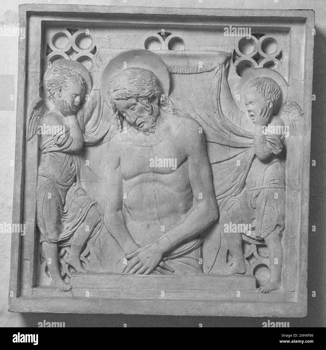 A relief depicting the dead Christ lying between two angels, showing ...