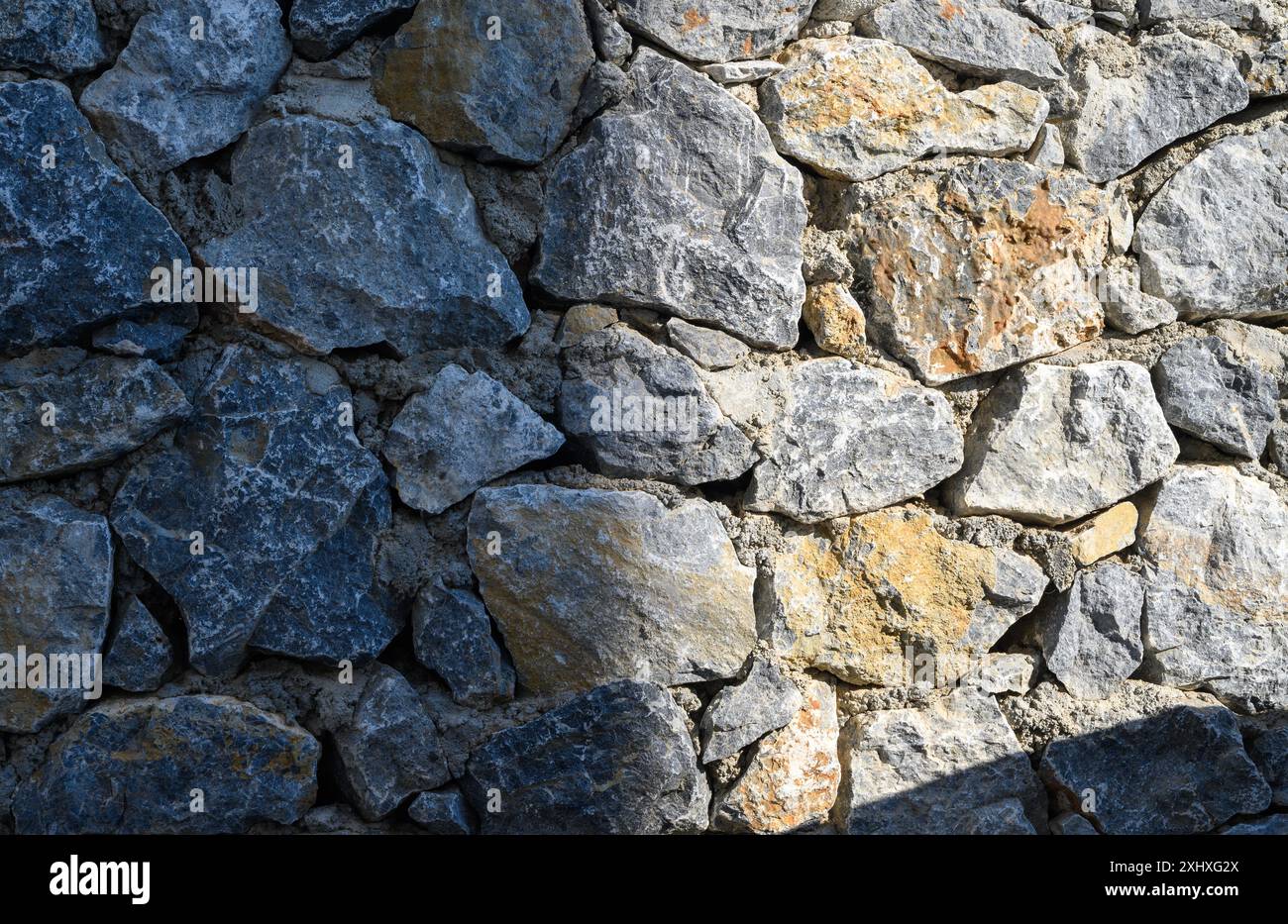 grey stone dark wall of medieval horizontal stones facade background ...