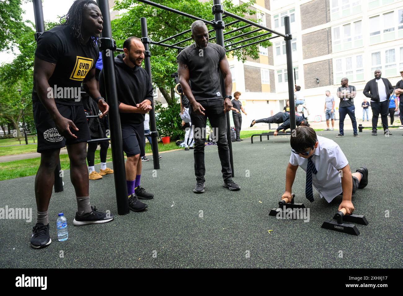 EDITORIAL USE ONLY Local resident, 7-year-old Ali (right) with a Gymbox ...