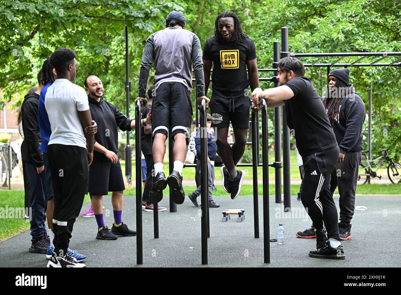 EDITORIAL USE ONLY Hester Campbell (centre), Gymbox trainer, with local ...