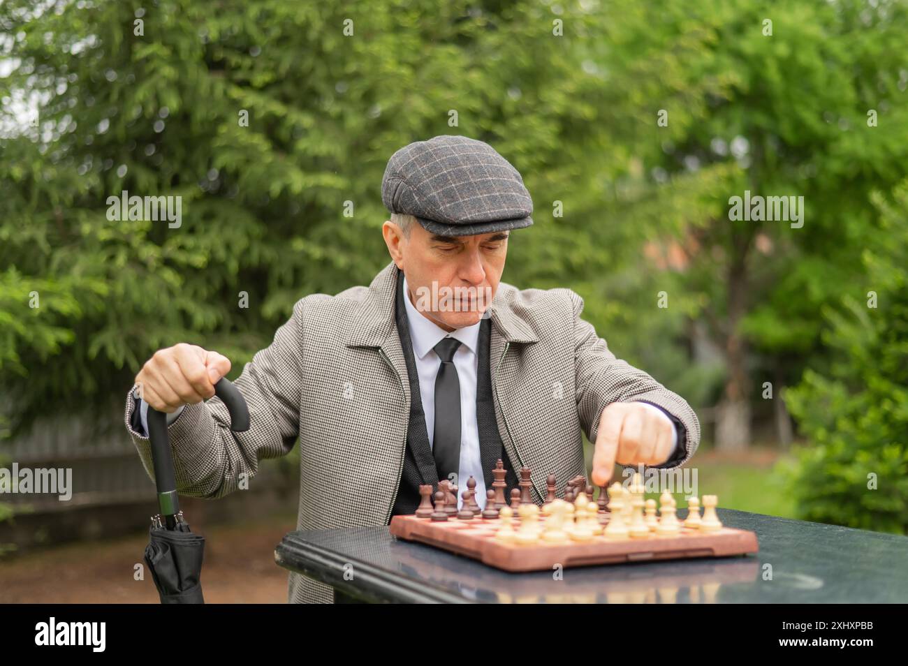Elderly Caucasian man playing chess outdoors Stock Photo - Alamy