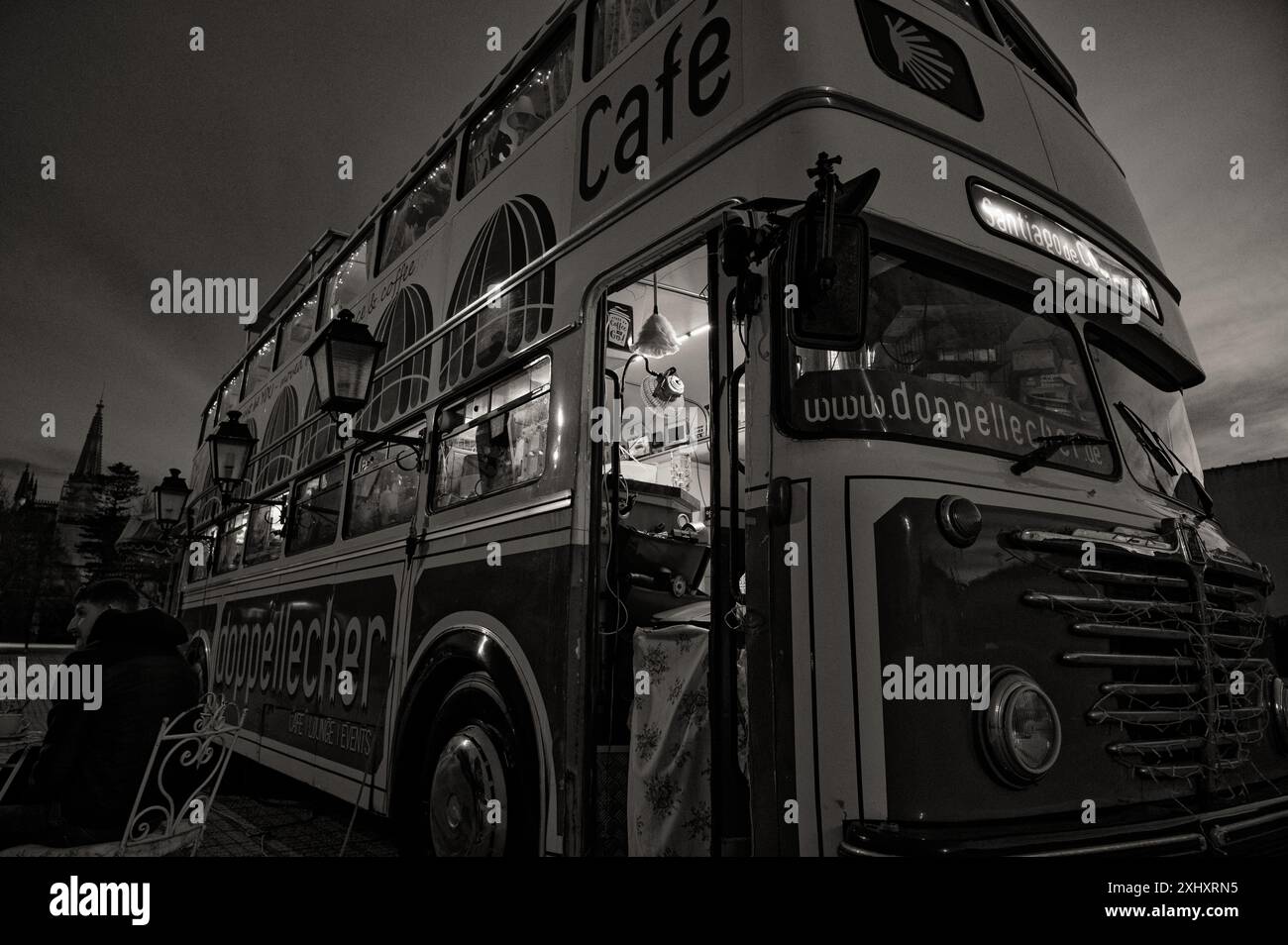 Monochrome of a double-decker bus cafe filled with people in Batalha ...