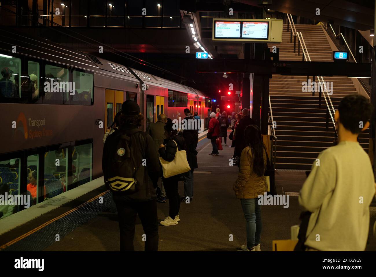 Commuters standing on the platform as a train pulls in at Sydenham ...