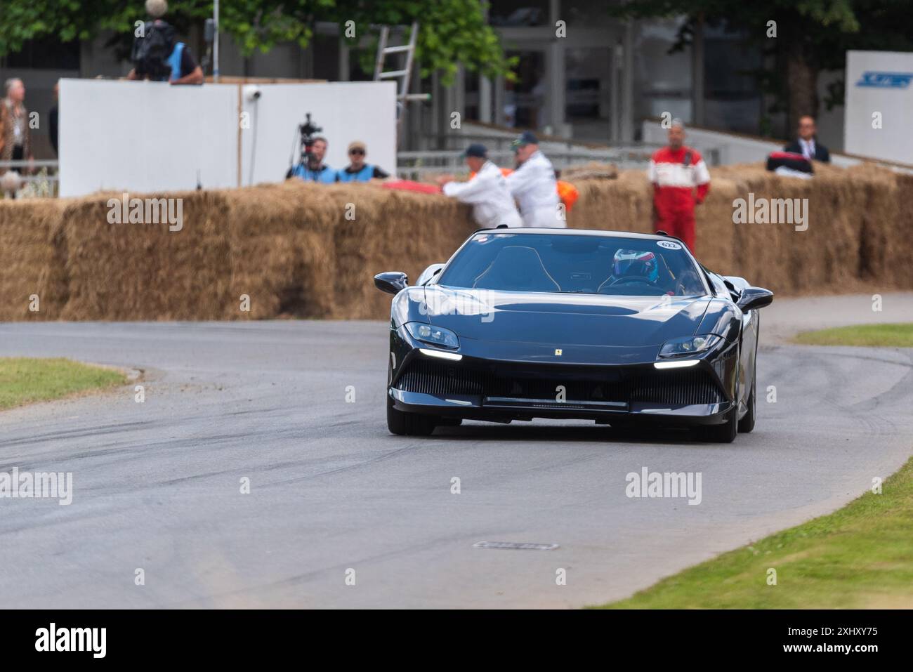 2023 Ferrari SP-8 driving up hill climb track at the Goodwood Festival ...