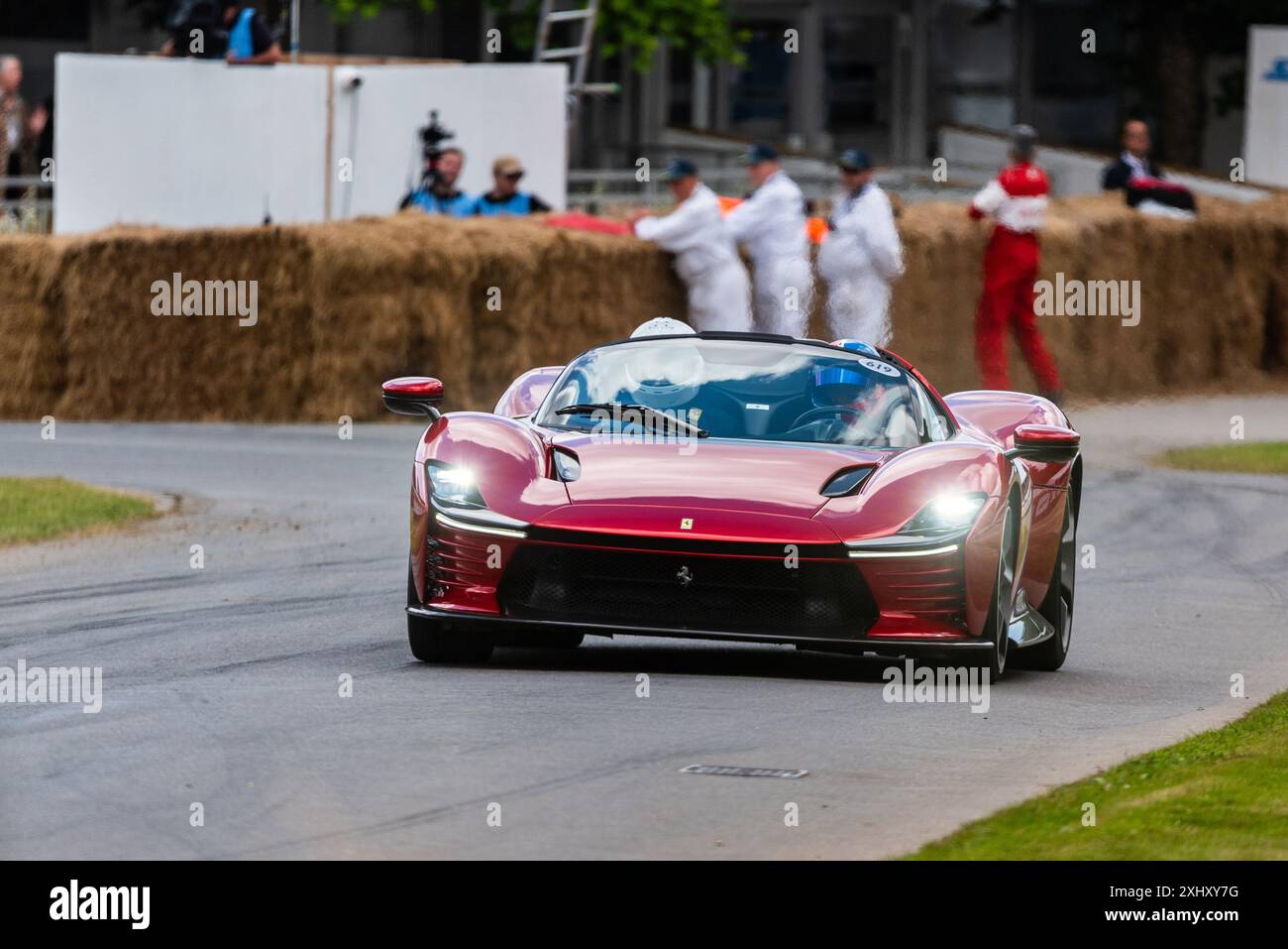 2023 Ferrari Daytona SP3 sports car driving up the hill climb track at ...