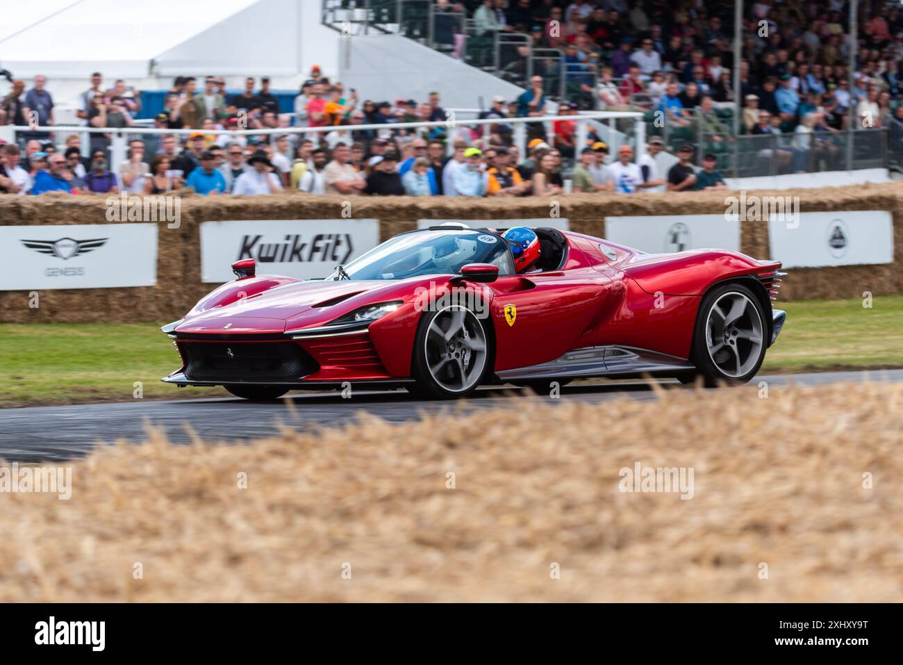 2023 Ferrari Daytona SP3 sports car driving up the hill climb track at ...