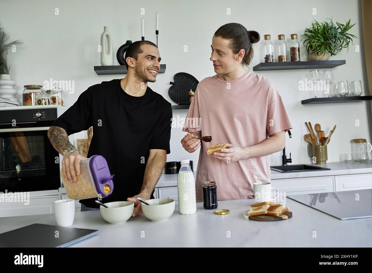 Two young men, a gay couple, prepare breakfast together in a modern ...
