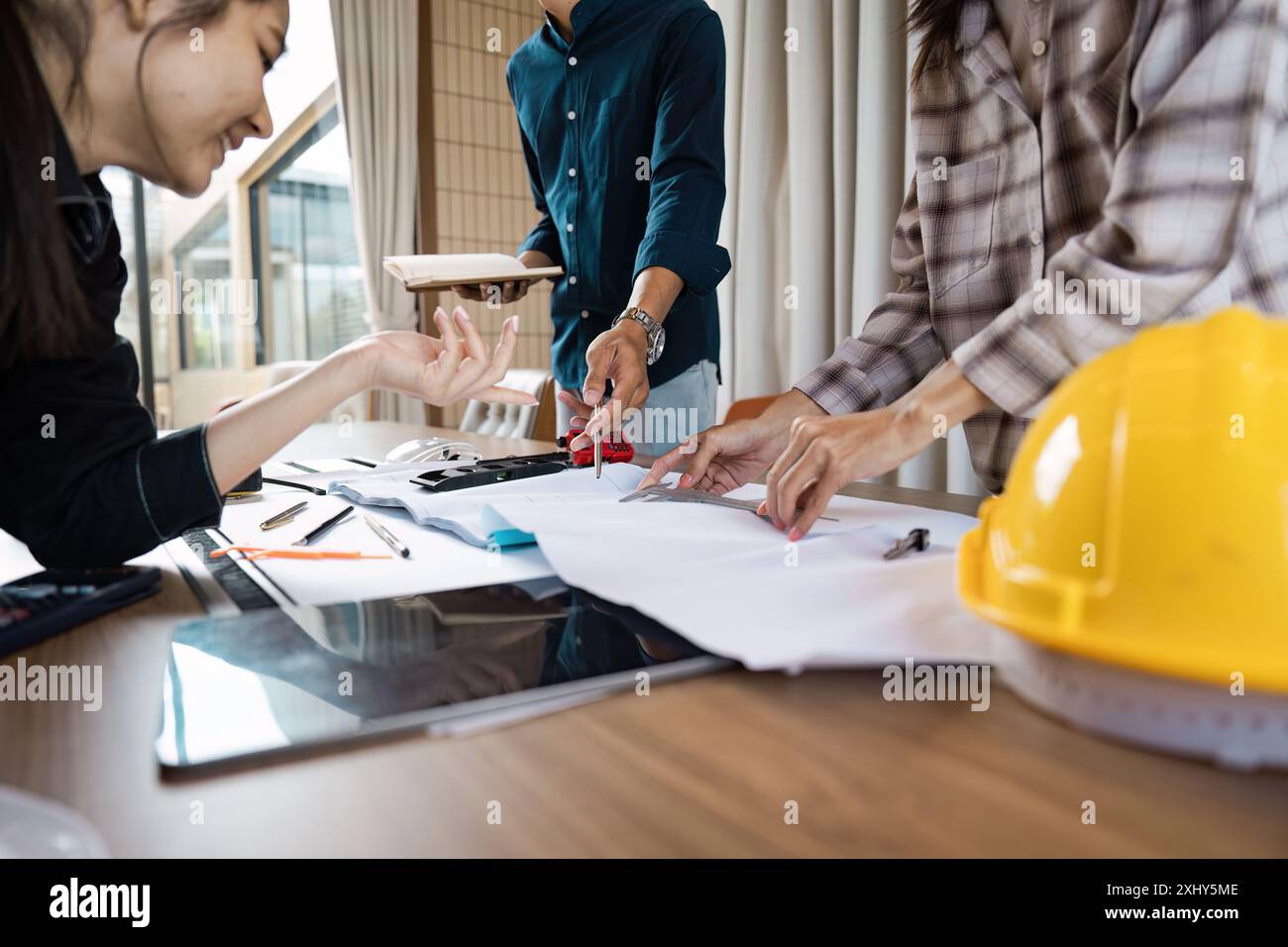 Team of Architect collaboration on Construction Project Plans in Modern ...