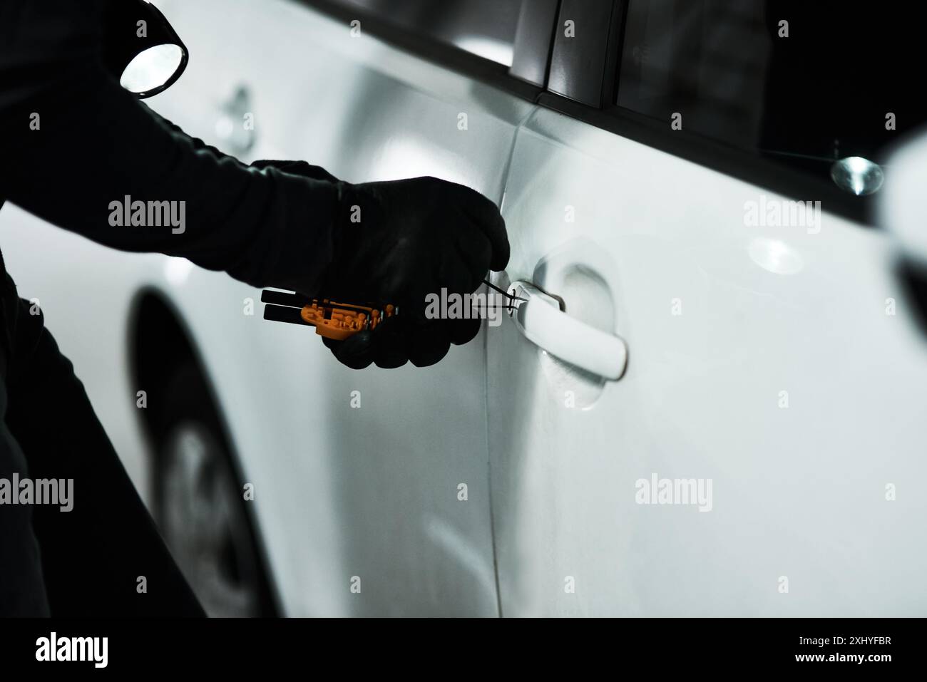 Car, handle and hands of criminal with tools for robbery, stealing and ...
