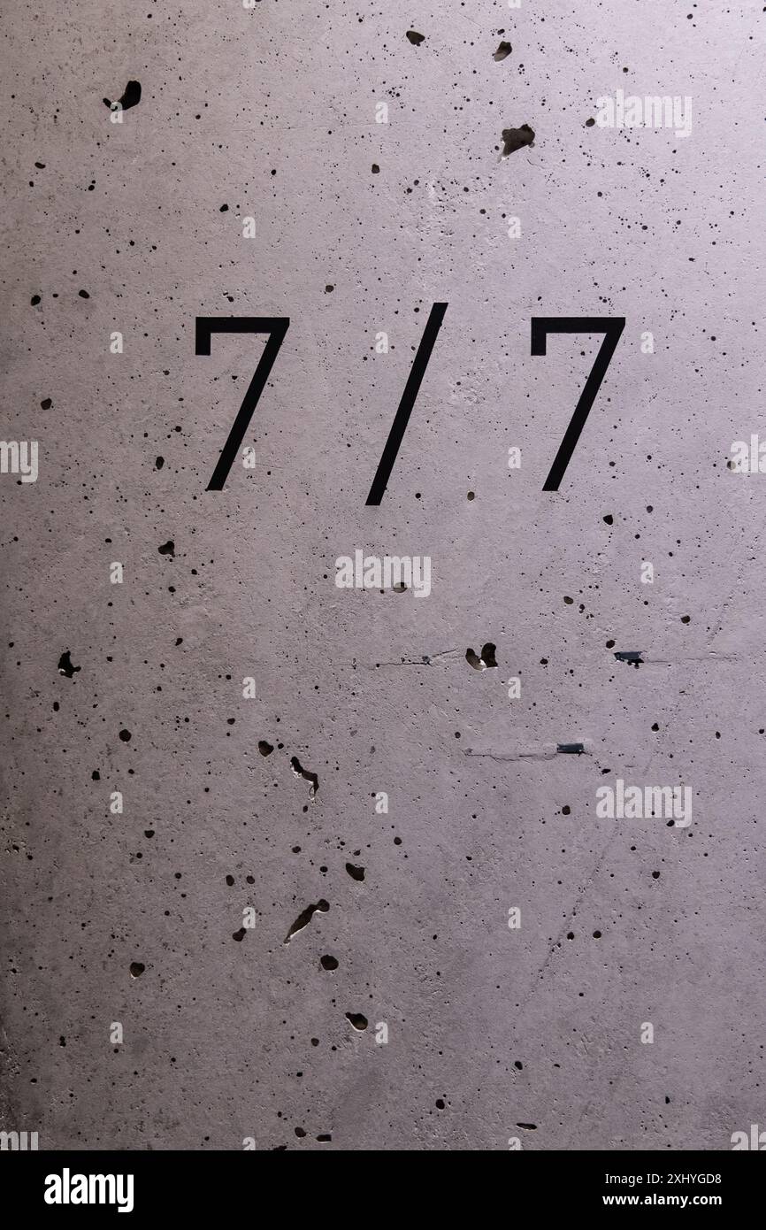 7 out of 7 black lettering on concrete wall background Stock Photo - Alamy