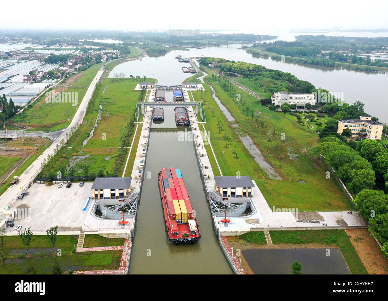 WUHU, CHINA - JULY 15, 2024 - Cargo ships pass through the Yuxi lock ...