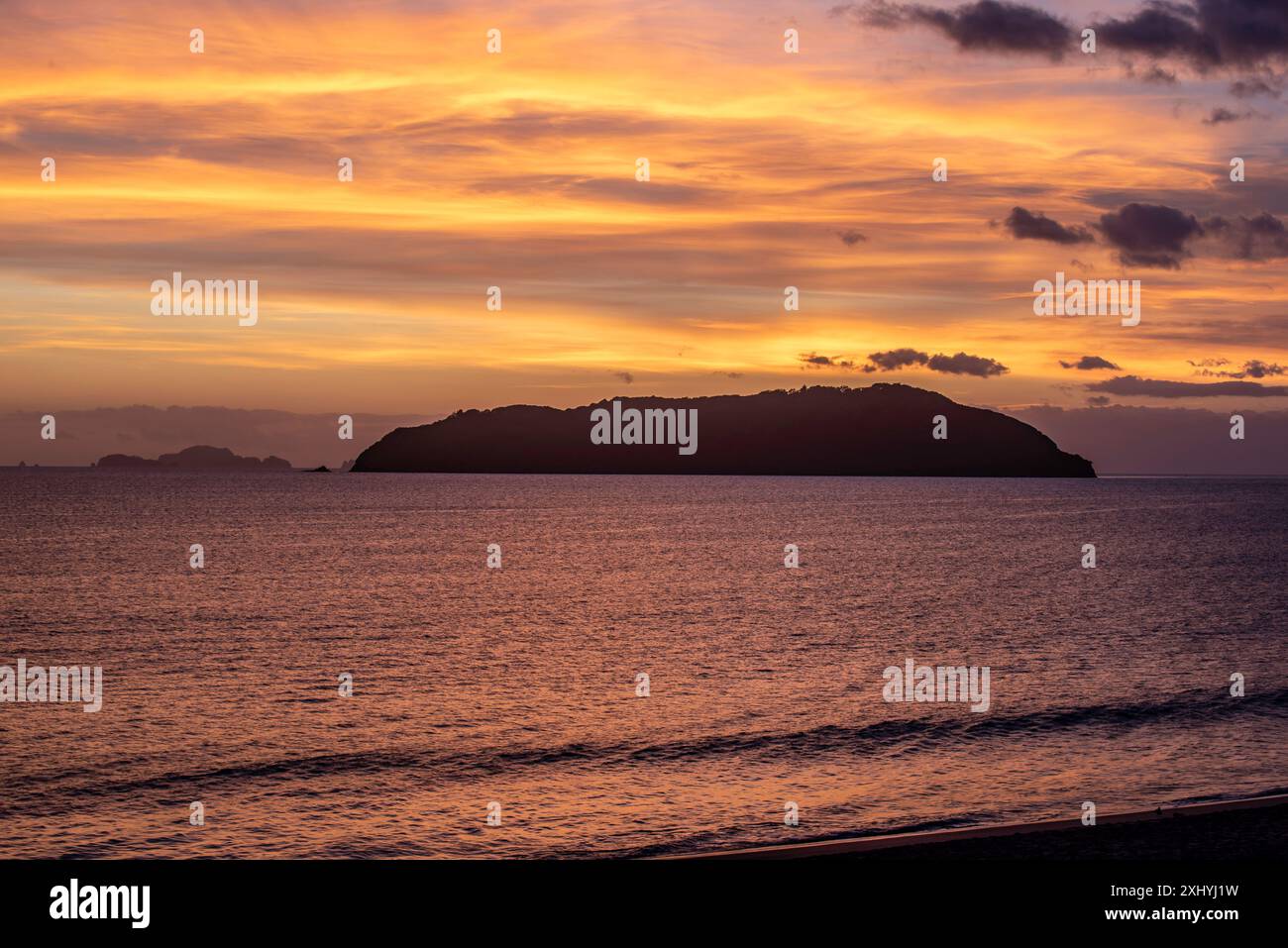 Sunrise over Shoe Island (Motuhoa) just off the coast of Tairua Beach ...