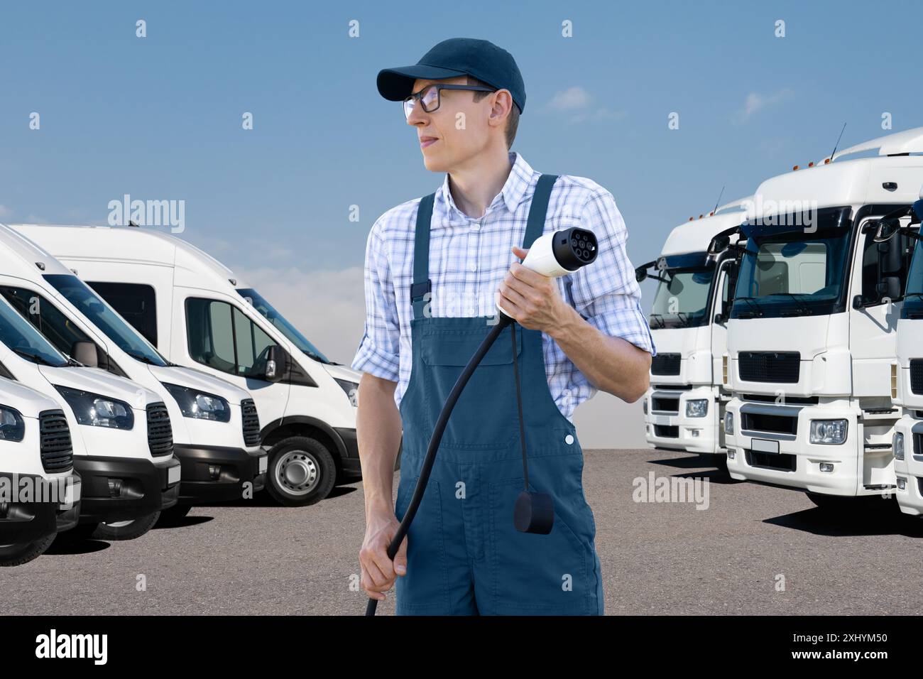Driver in uniform holds electric vehicle charging plug. Electric fleet ...