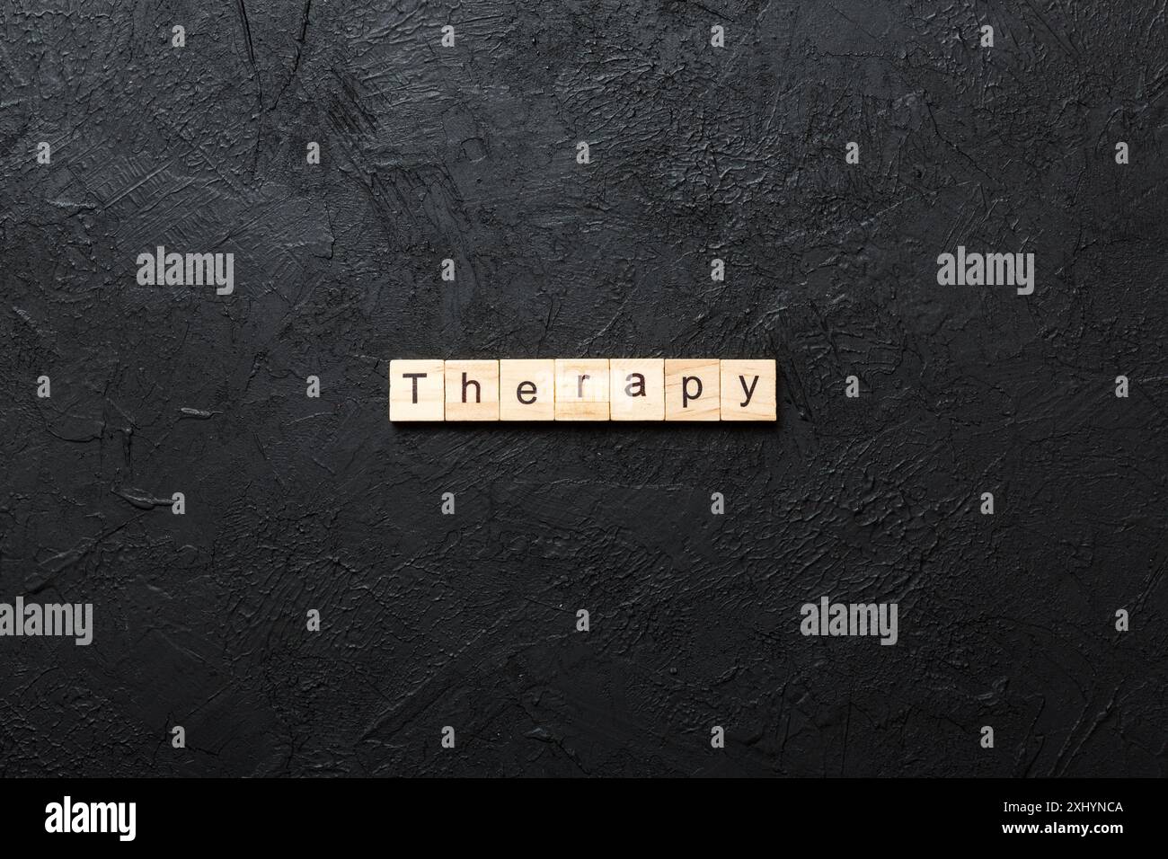 therapy word written on wood block. therapy text on cement table for ...
