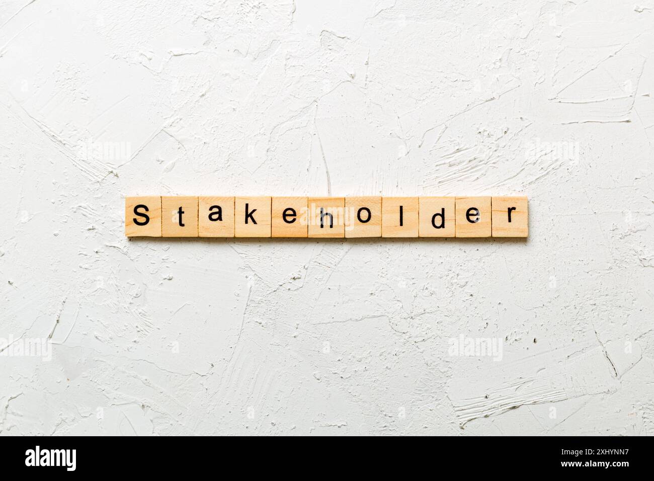 Stakeholder word written on wood block. Stakeholder text on cement table for your desing ...