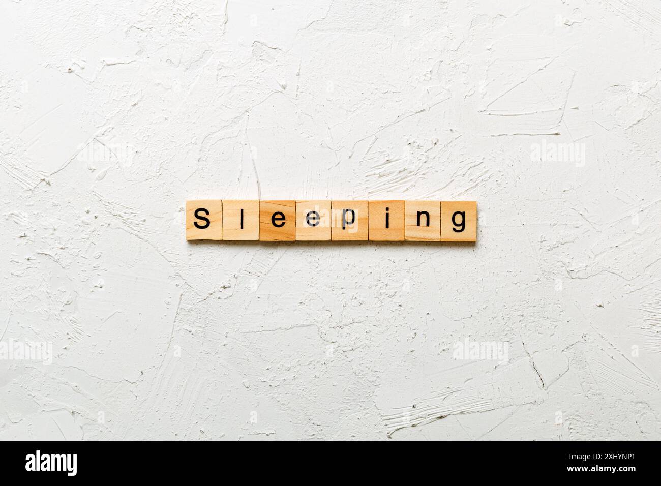 SLEEPING word written on wood block. SLEEPING text on cement table for ...
