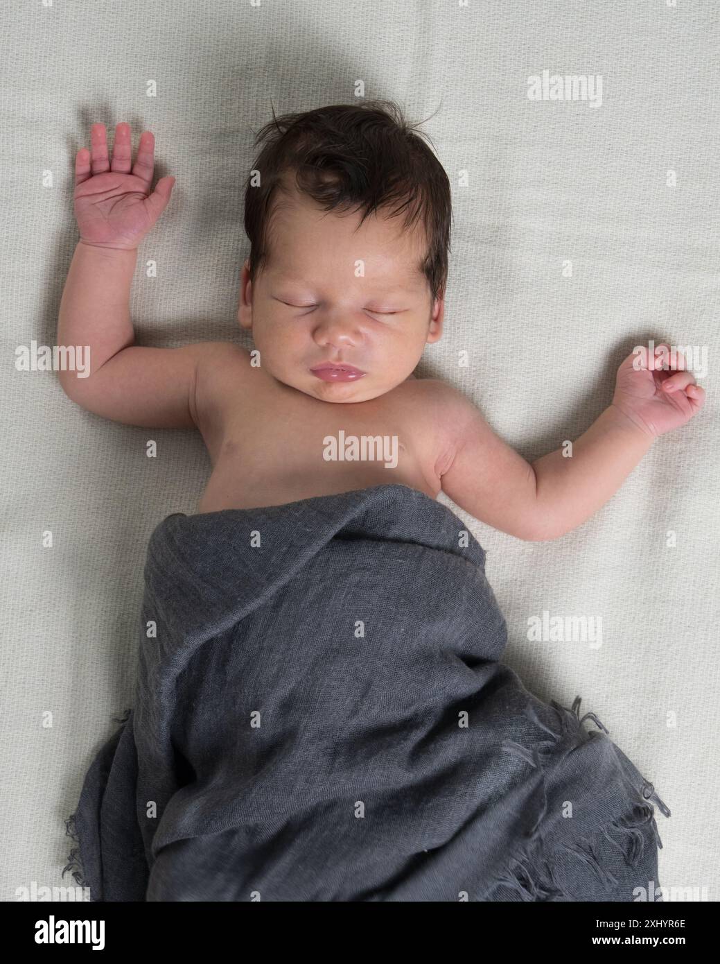 Newborn baby in the first days of life. A cute little newborn boy lies ...