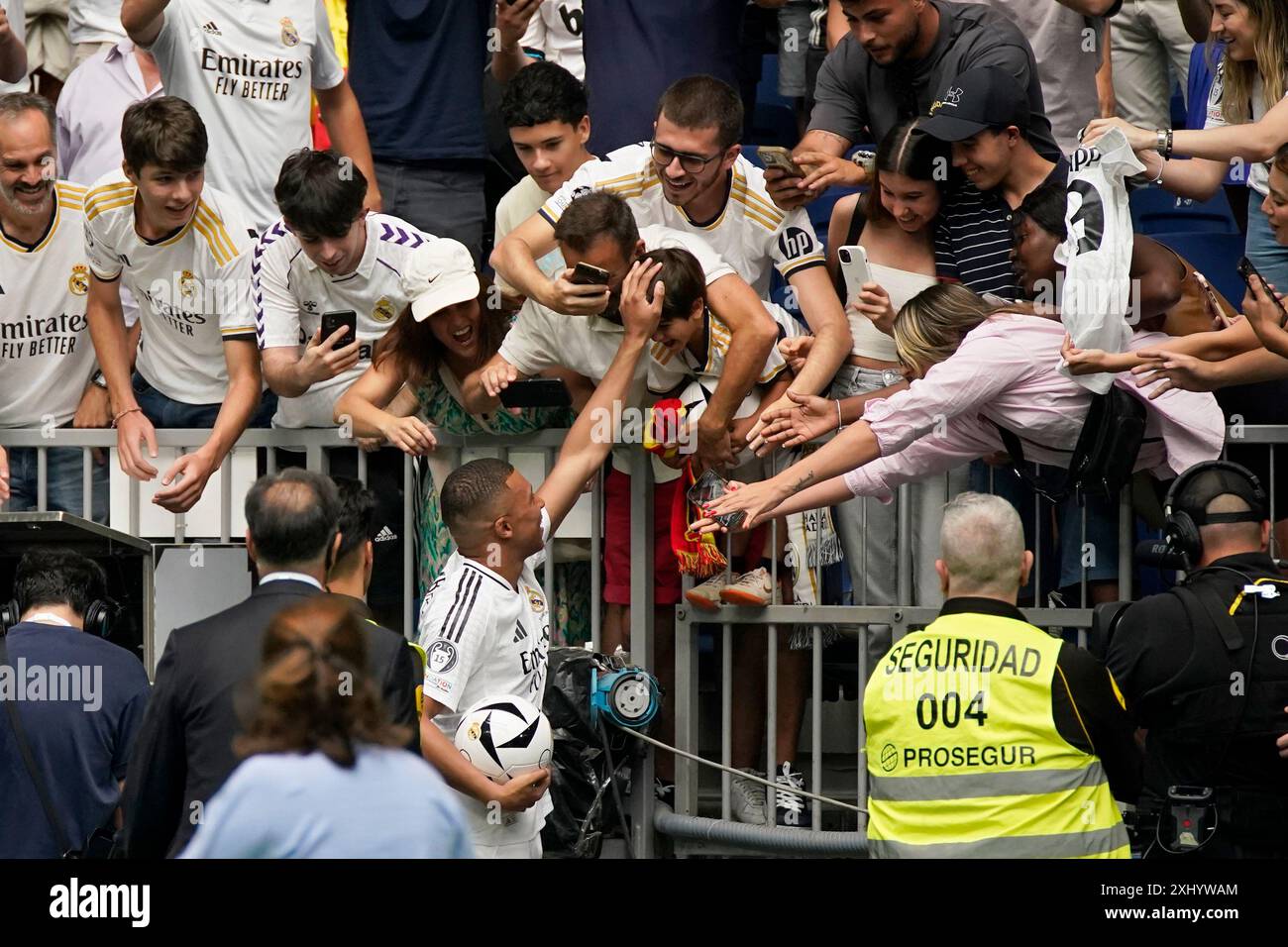 Kylian Mbappe, of France, greets fans after being presented as a new ...